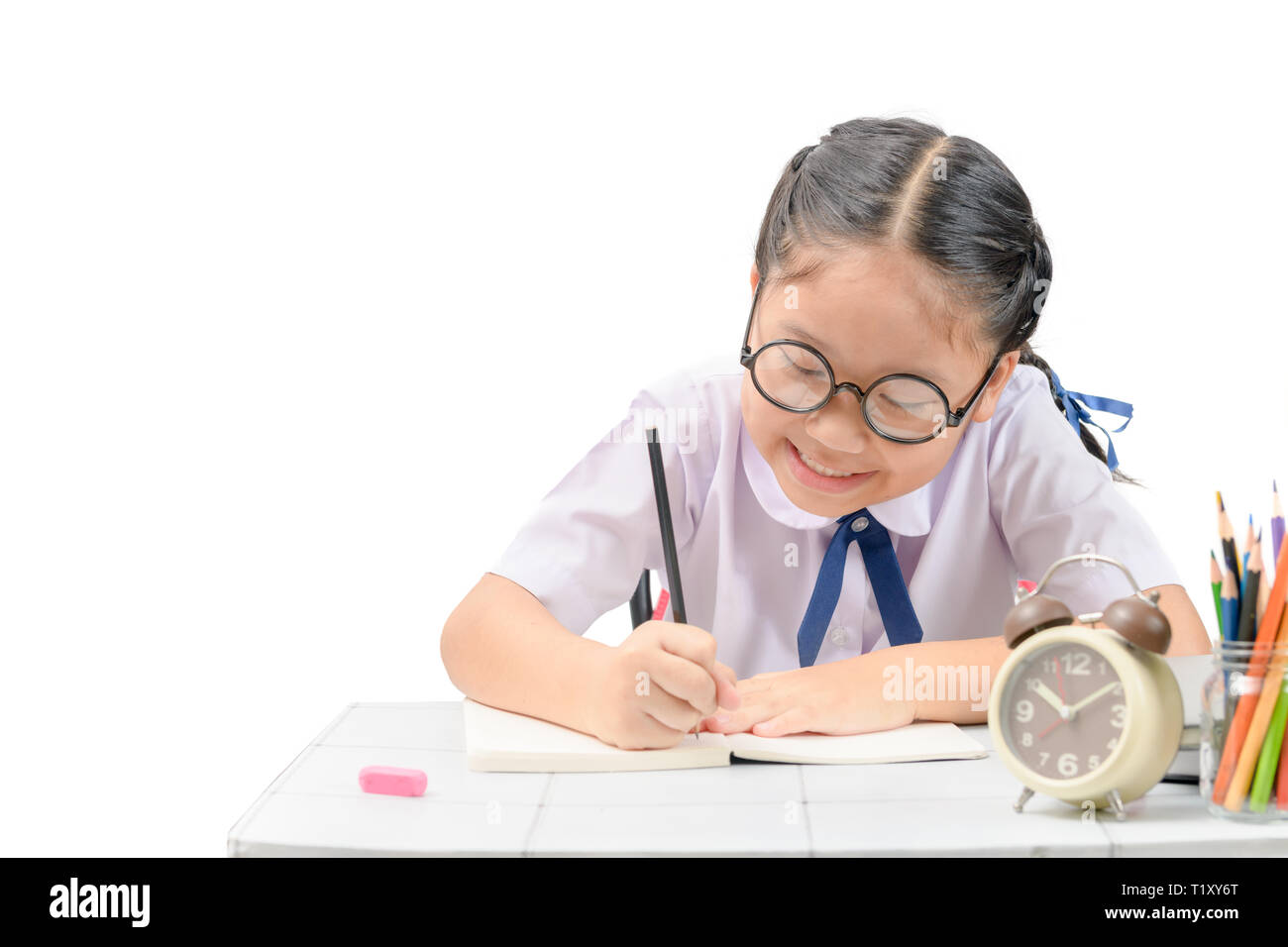 Cute asian student doing homework on table isolated and copy space on ...