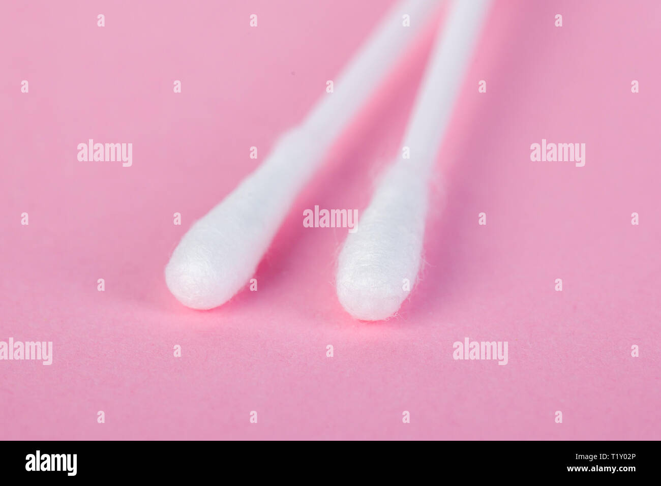 sticks for cleaning ears on a pink background, medicine Stock Photo - Alamy