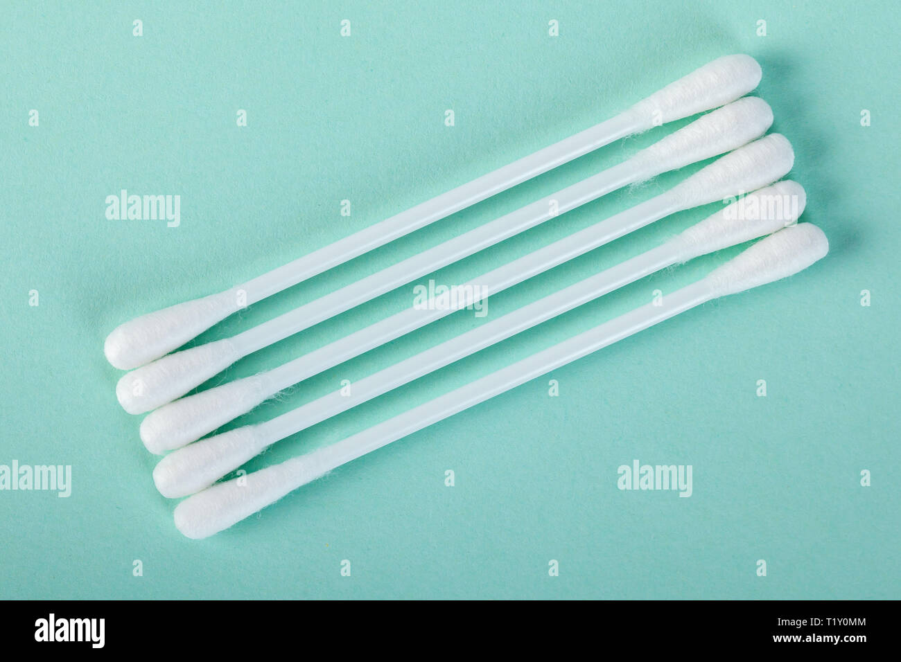 sticks for cleaning ears on a green background, medicine Stock Photo ...
