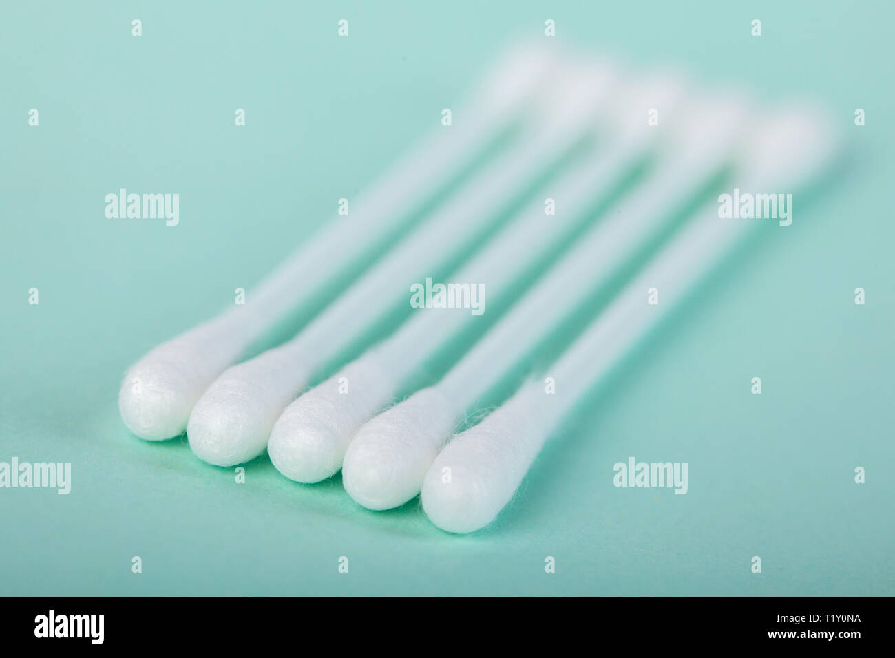 sticks for cleaning ears on a green background, medicine Stock Photo ...