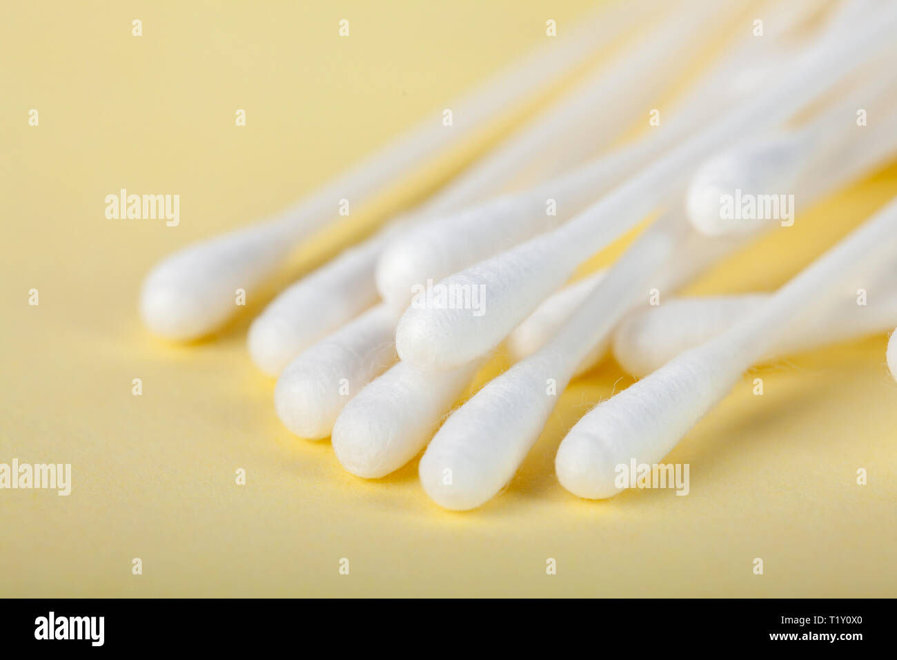sticks for cleaning ears on a yellow background, medicine Stock Photo ...