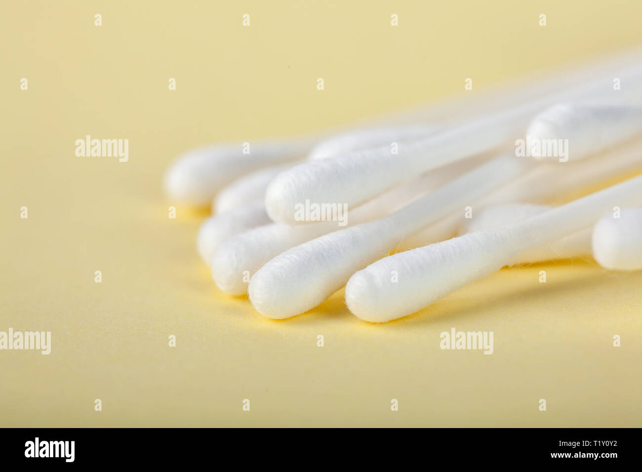 sticks for cleaning ears on a yellow background, medicine Stock Photo ...