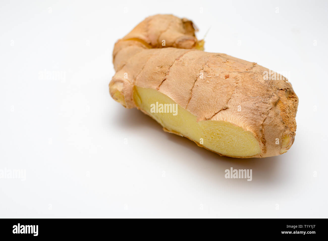Fresh Ginger root cut and isolated on white Stock Photo - Alamy