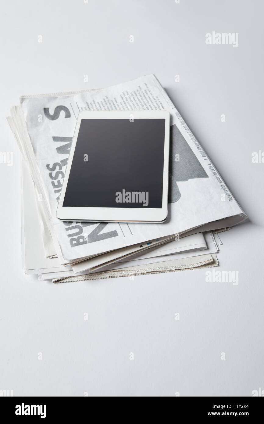 digital tablet with blank screen on business newspapers on white Stock ...