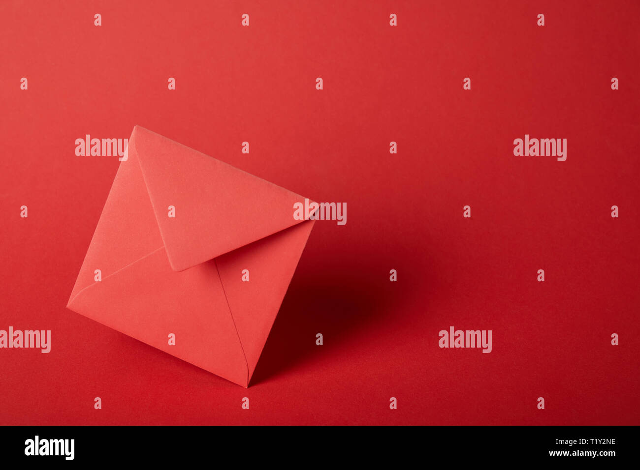 bright, colorful and empty envelope on red background with copy space ...