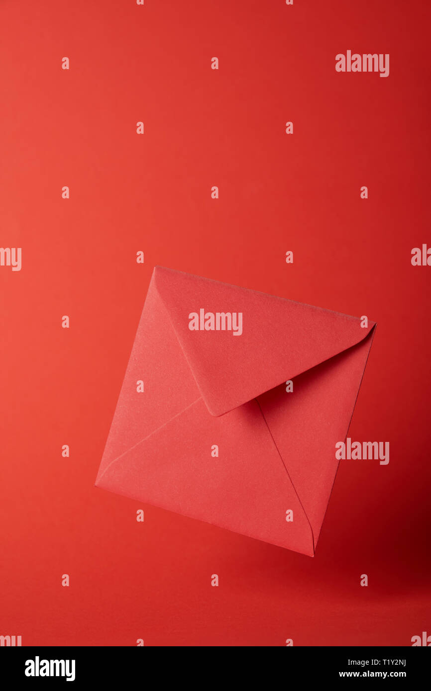 bright, colorful and empty envelope on red background with copy space ...