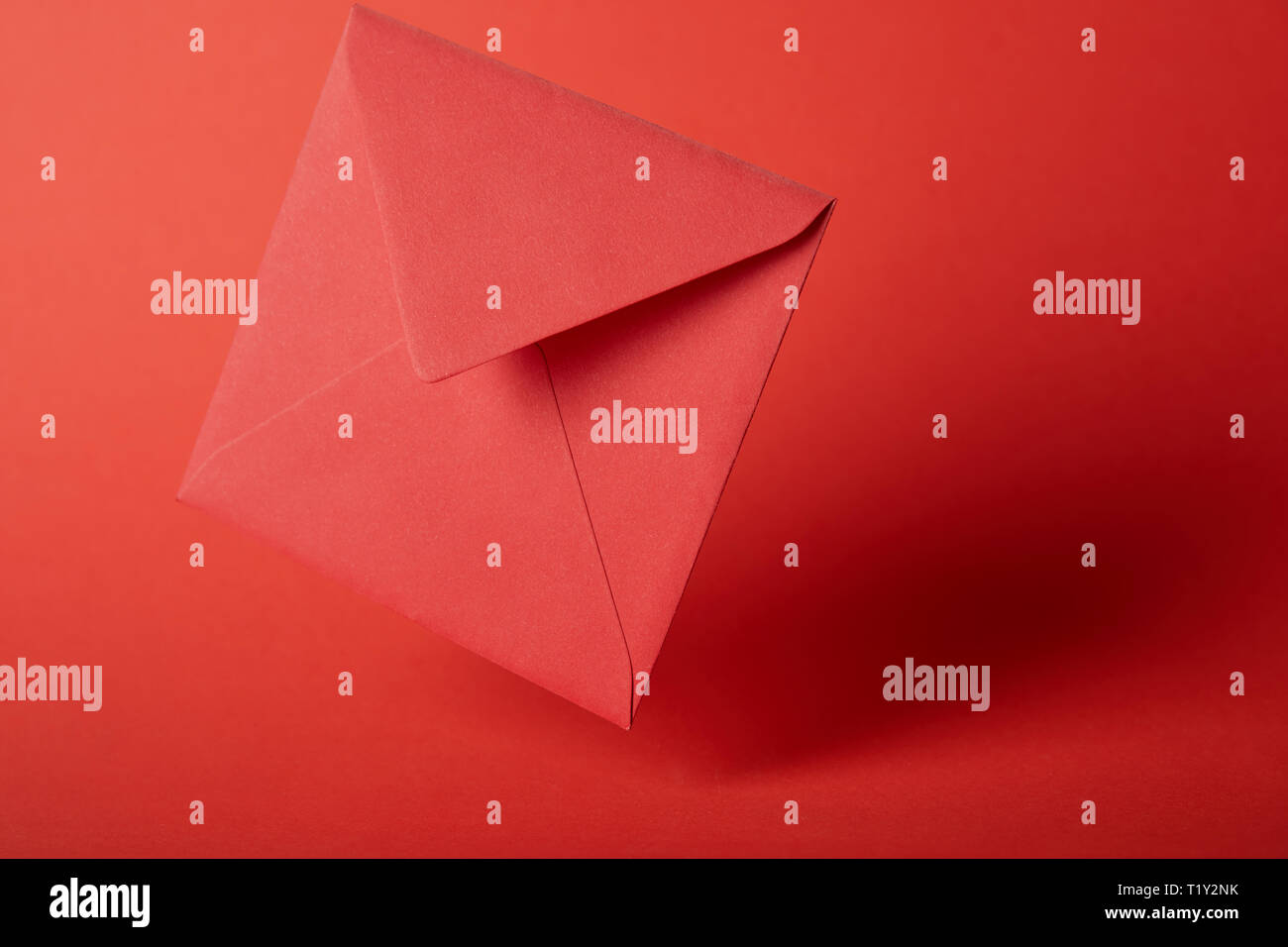 bright, colorful and empty envelope on red background with copy space ...