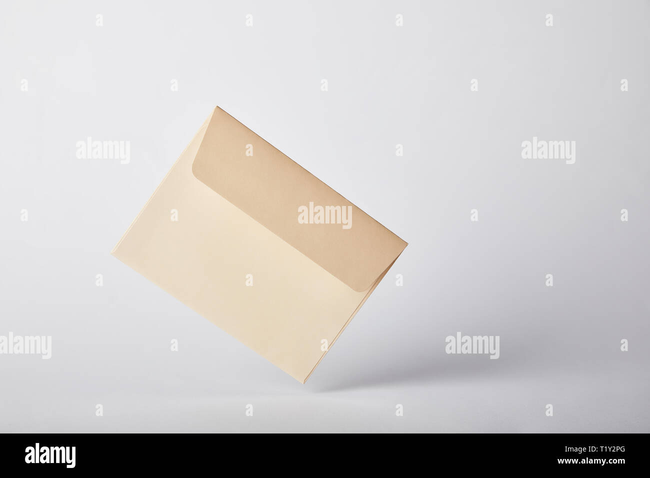beige and empty envelope on grey background with copy space Stock Photo ...