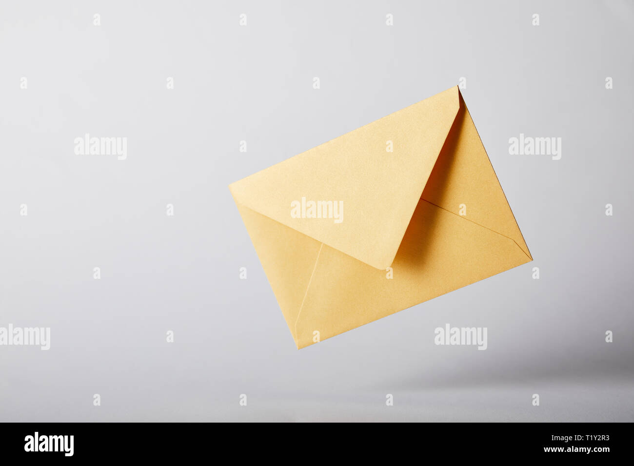 yellow and bright envelope on grey background with copy space Stock ...