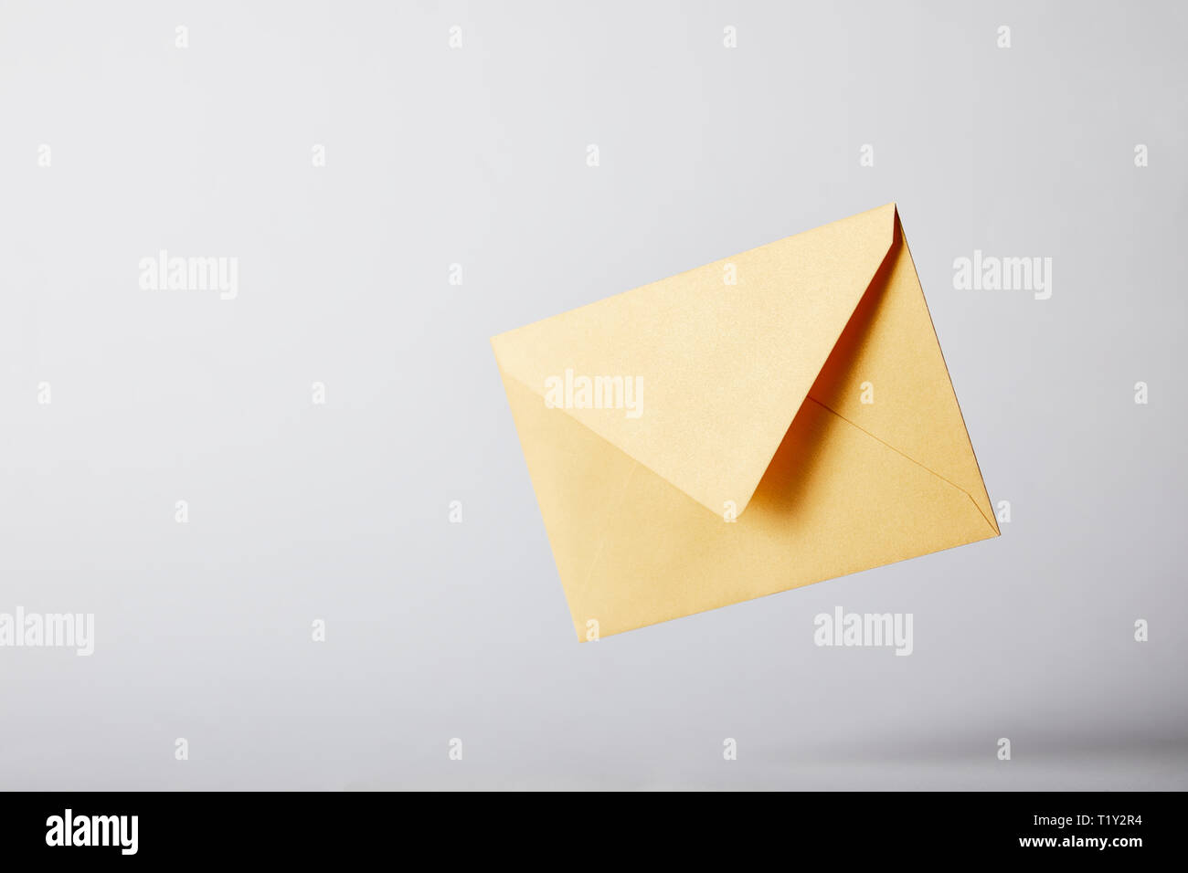 yellow and bright envelope on grey background with copy space Stock ...