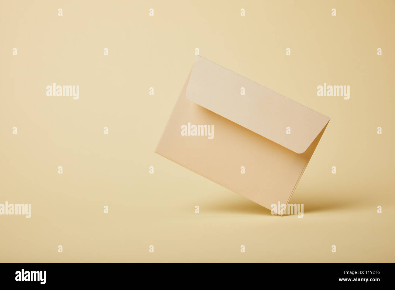 beige and pastel envelope on yellow background with copy space Stock ...