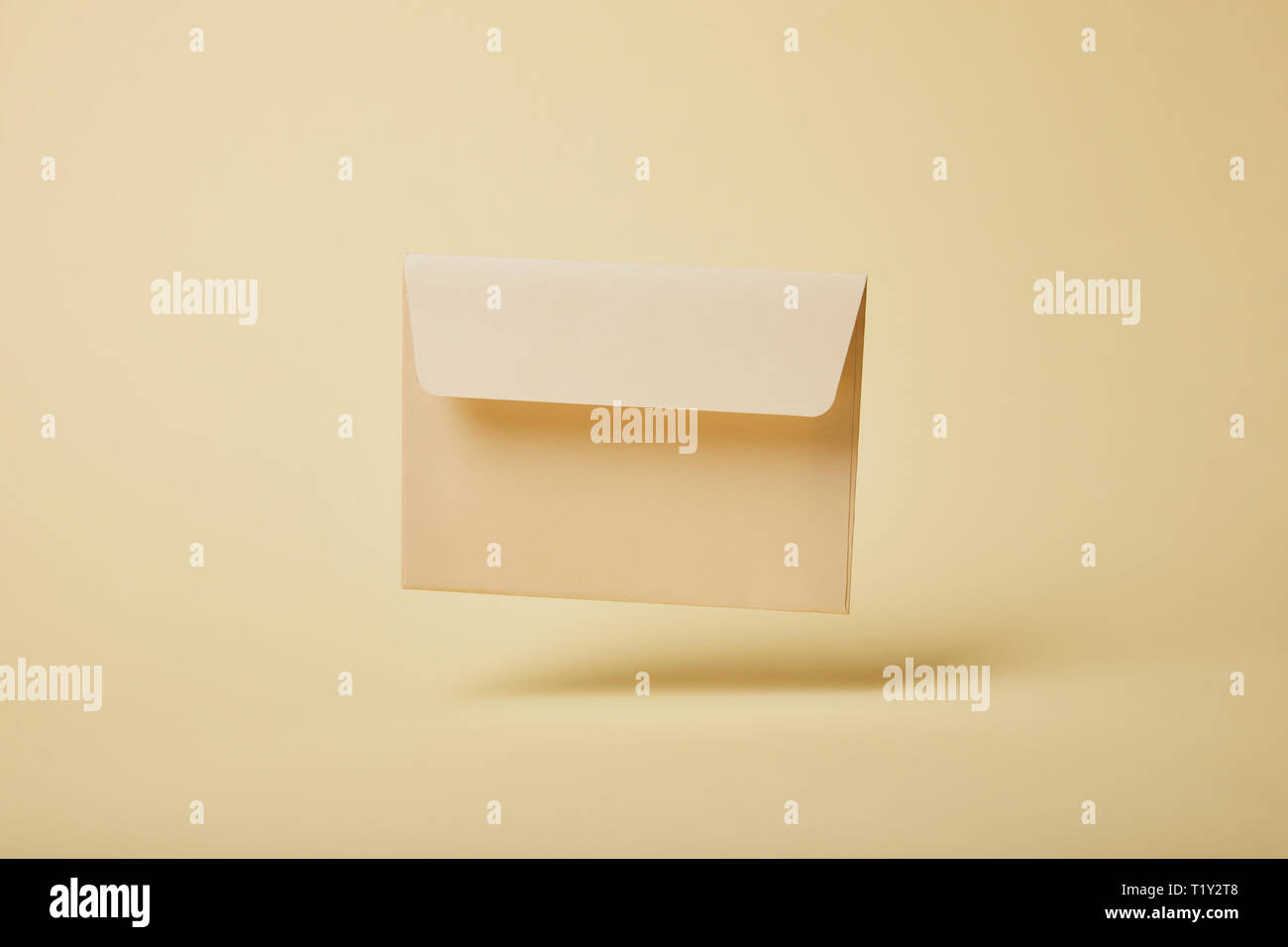 beige and blank envelope on yellow background with copy space Stock ...