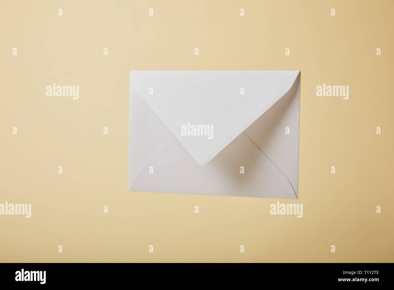 white and empty envelope on yellow background with copy space Stock ...
