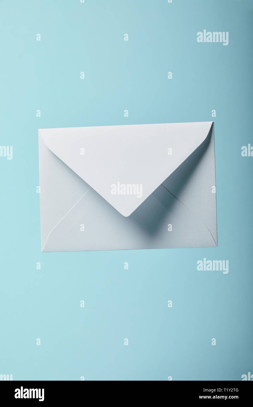 white and empty envelope on blue background with copy space Stock Photo ...