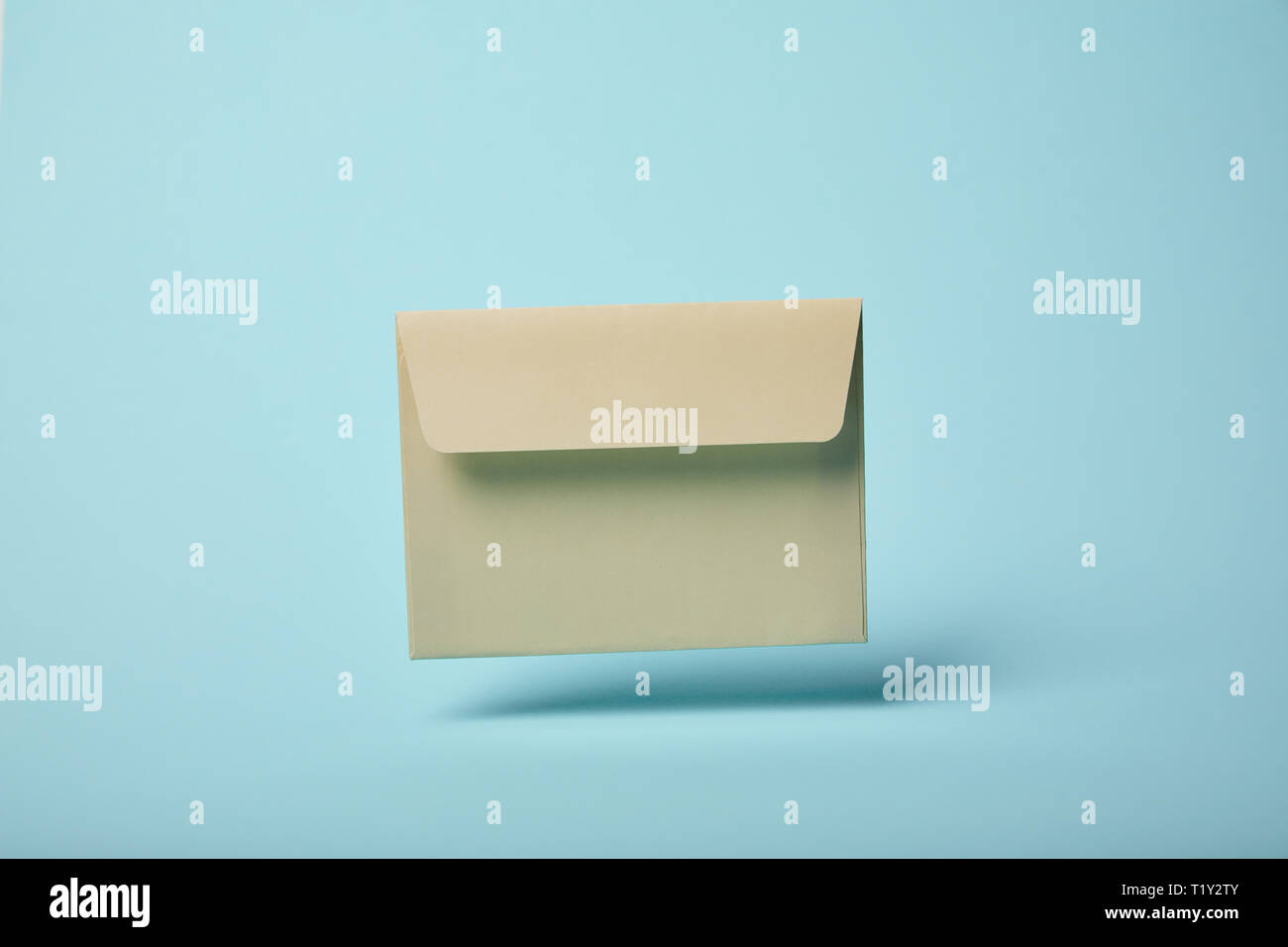 beige and empty envelope on blue background with copy space Stock Photo ...