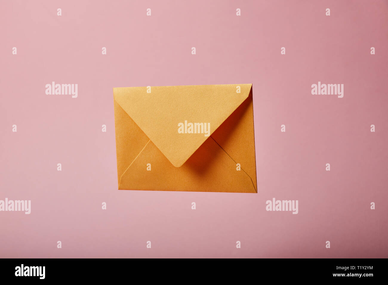 yellow and bright envelope on pink background with copy space Stock ...