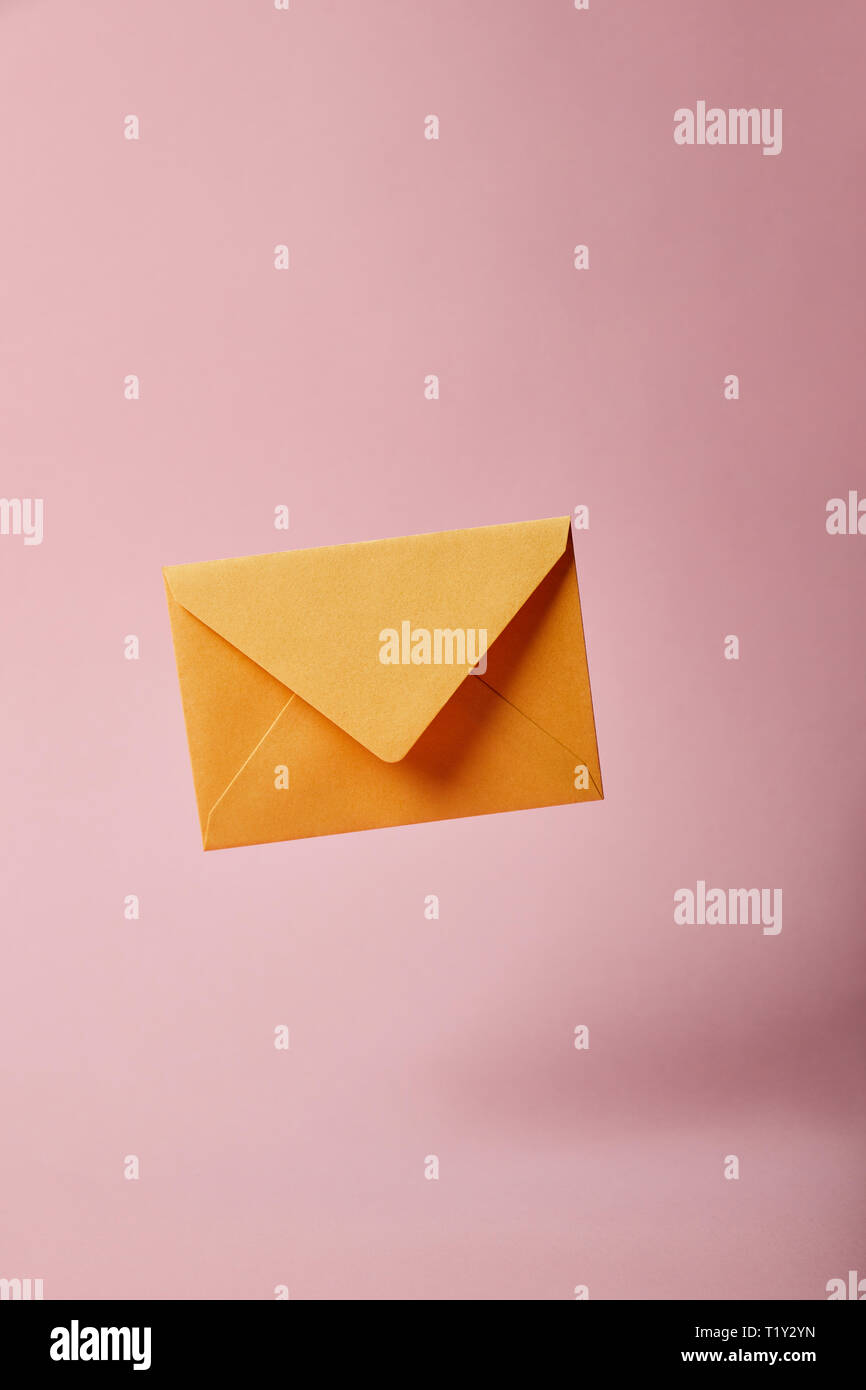 yellow and bright envelope on pink background with copy space Stock ...