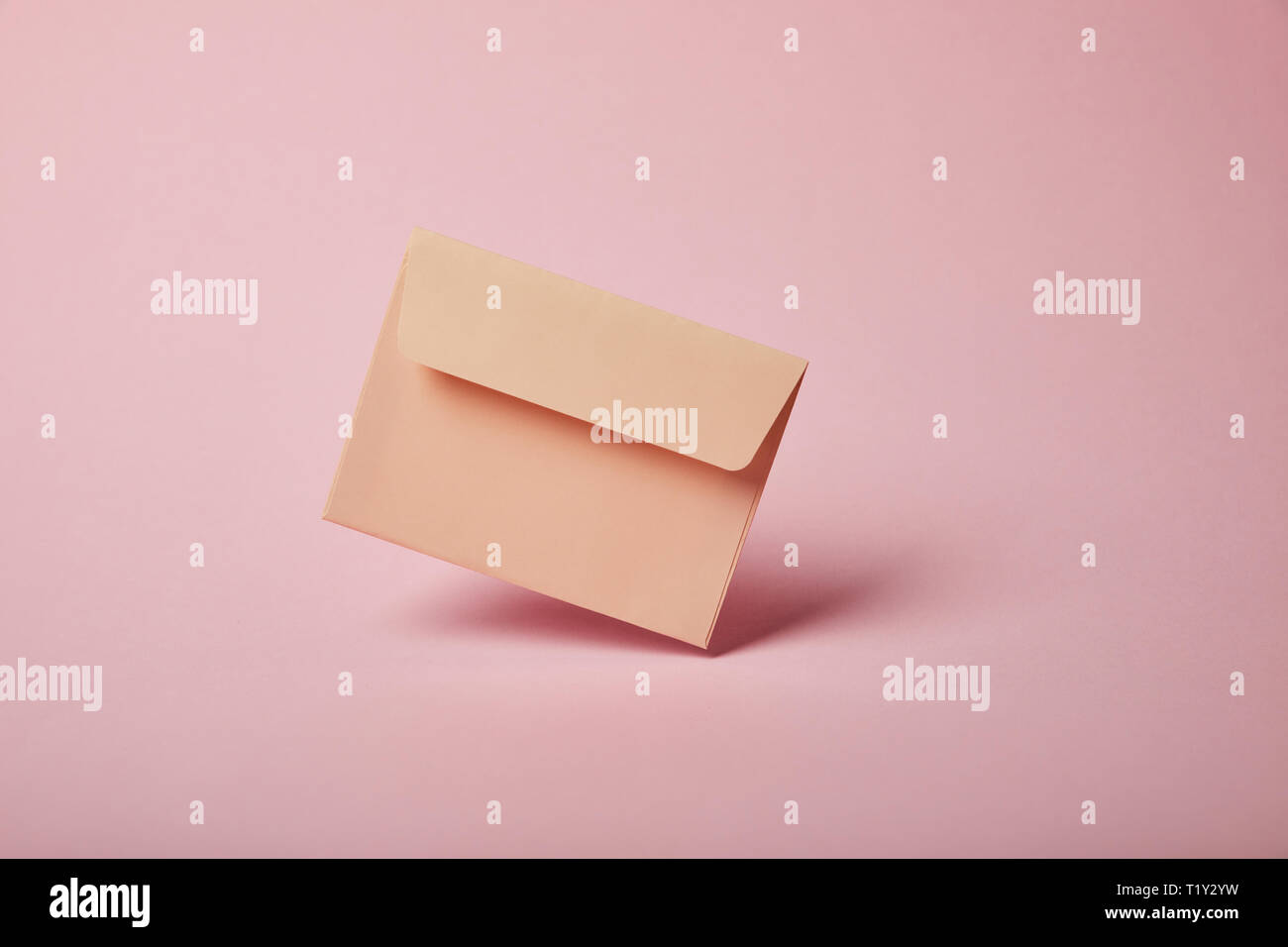 beige and empty envelope on pink background with copy space Stock Photo ...