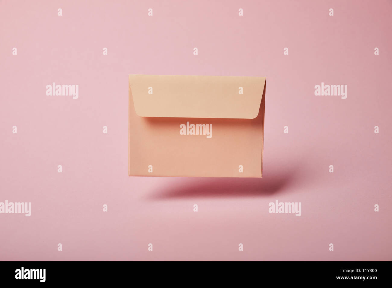 beige and empty envelope on pink background with copy space Stock Photo ...