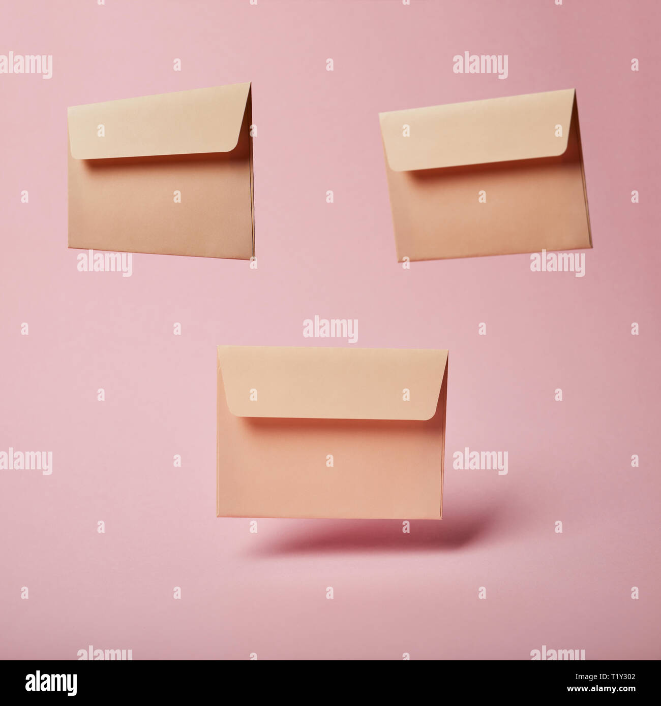 beige envelopes with copy space on pink and pastel background Stock ...