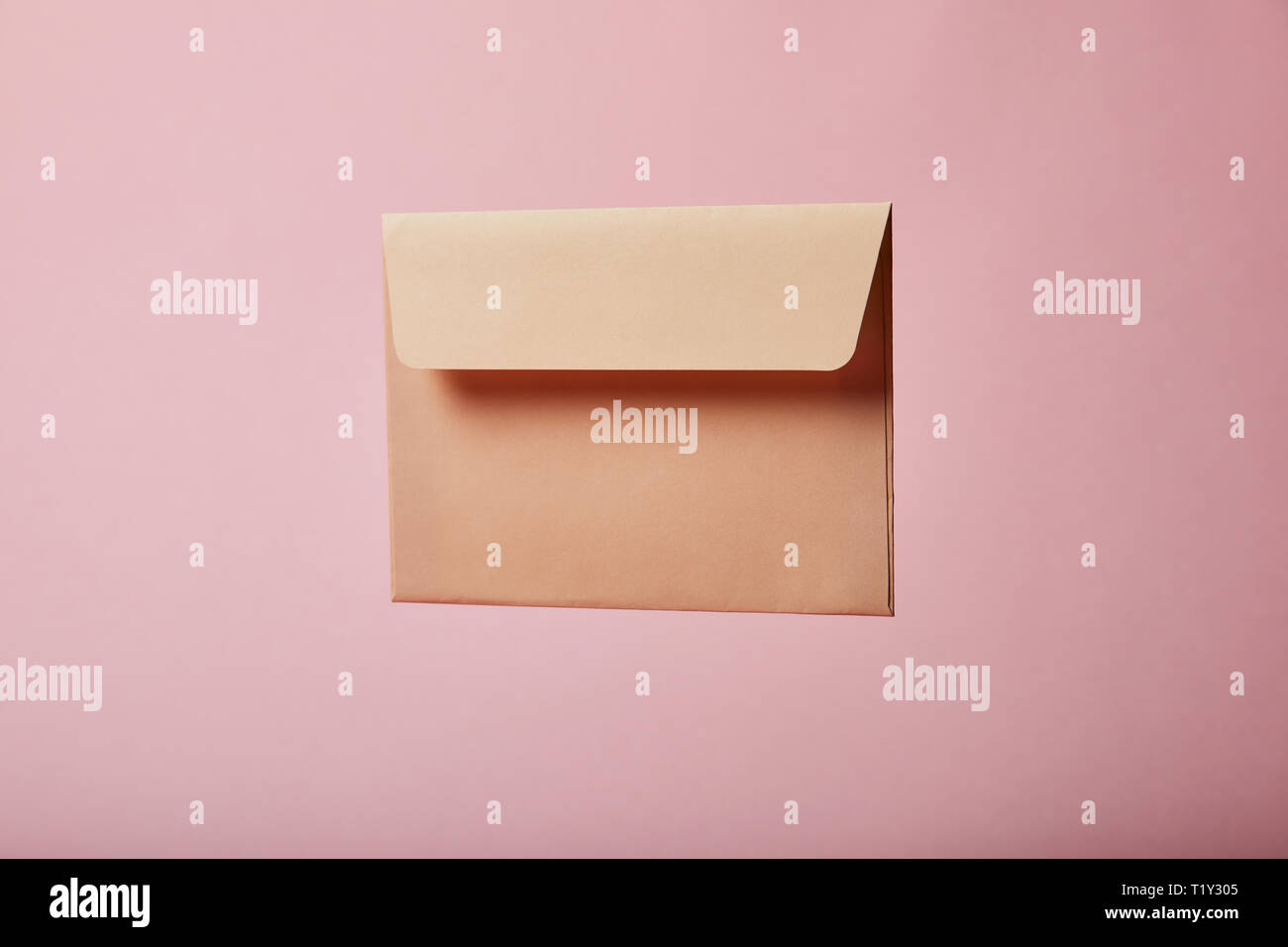beige and empty envelope on pink background with copy space Stock Photo ...