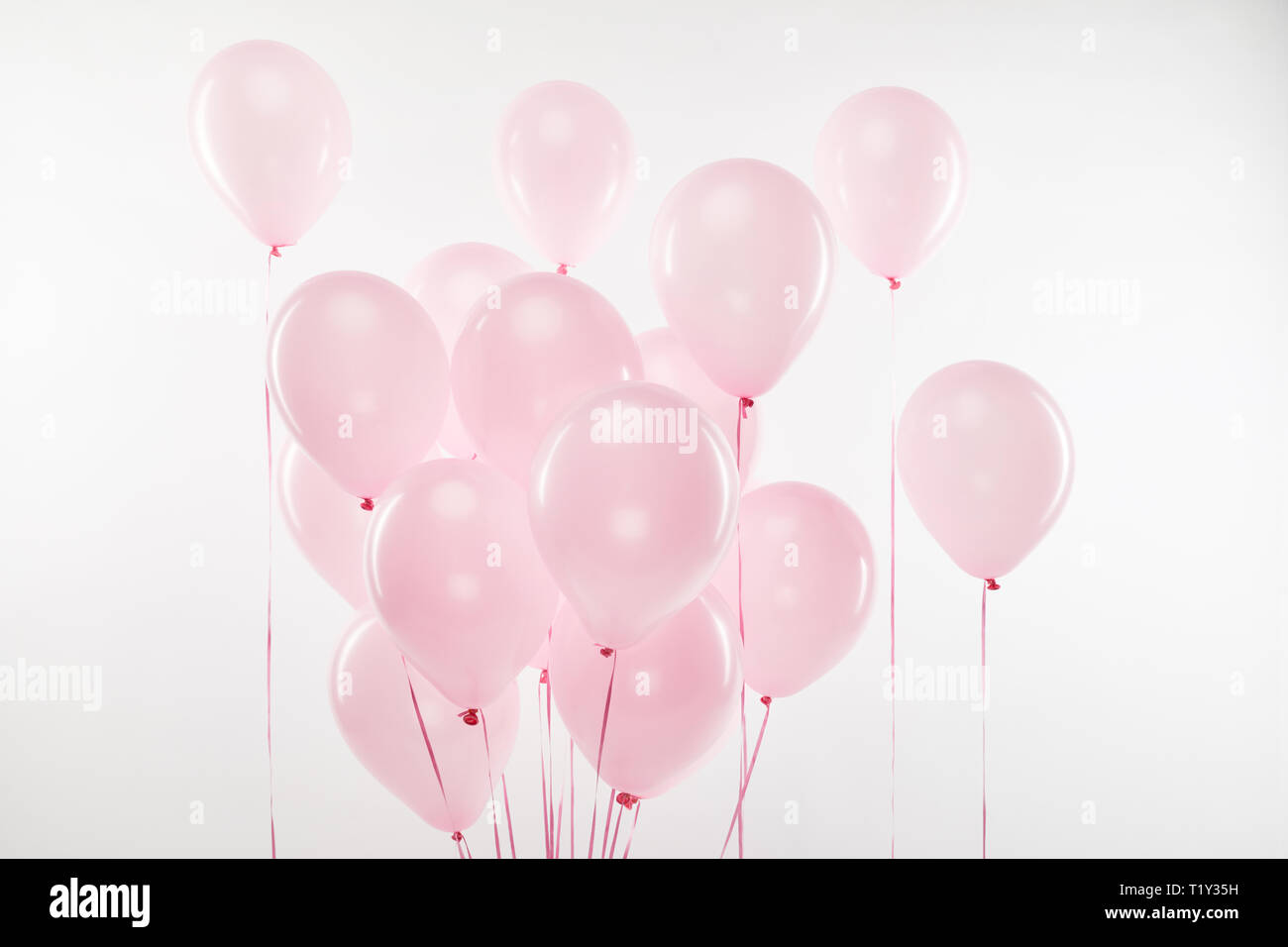 background with bundle of decorative pink air balloons on white Stock ...