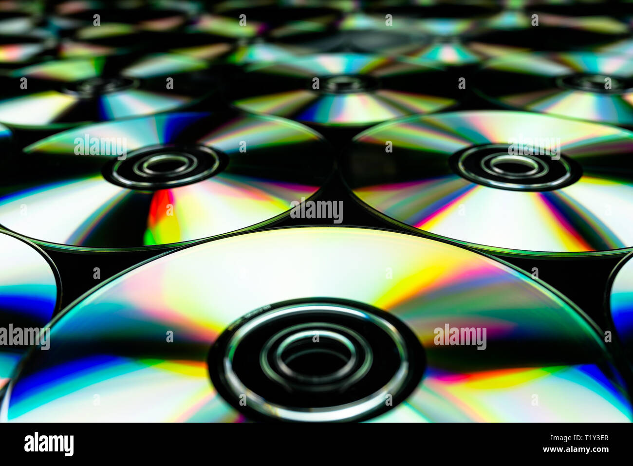 CDs / DVDs lying on a black background with reflections of light Stock ...