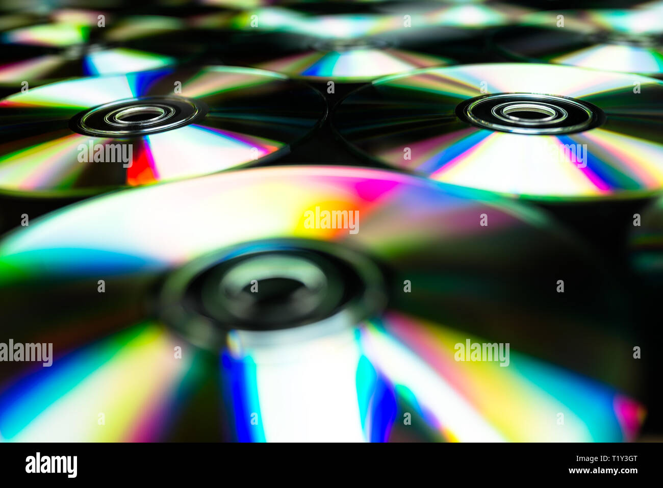 CDs / DVDs lying on a black background with reflections of light Stock ...