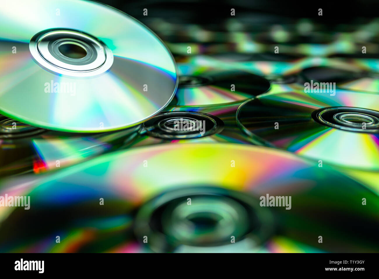 CDs / DVDs lying on a black background with reflections of light Stock ...