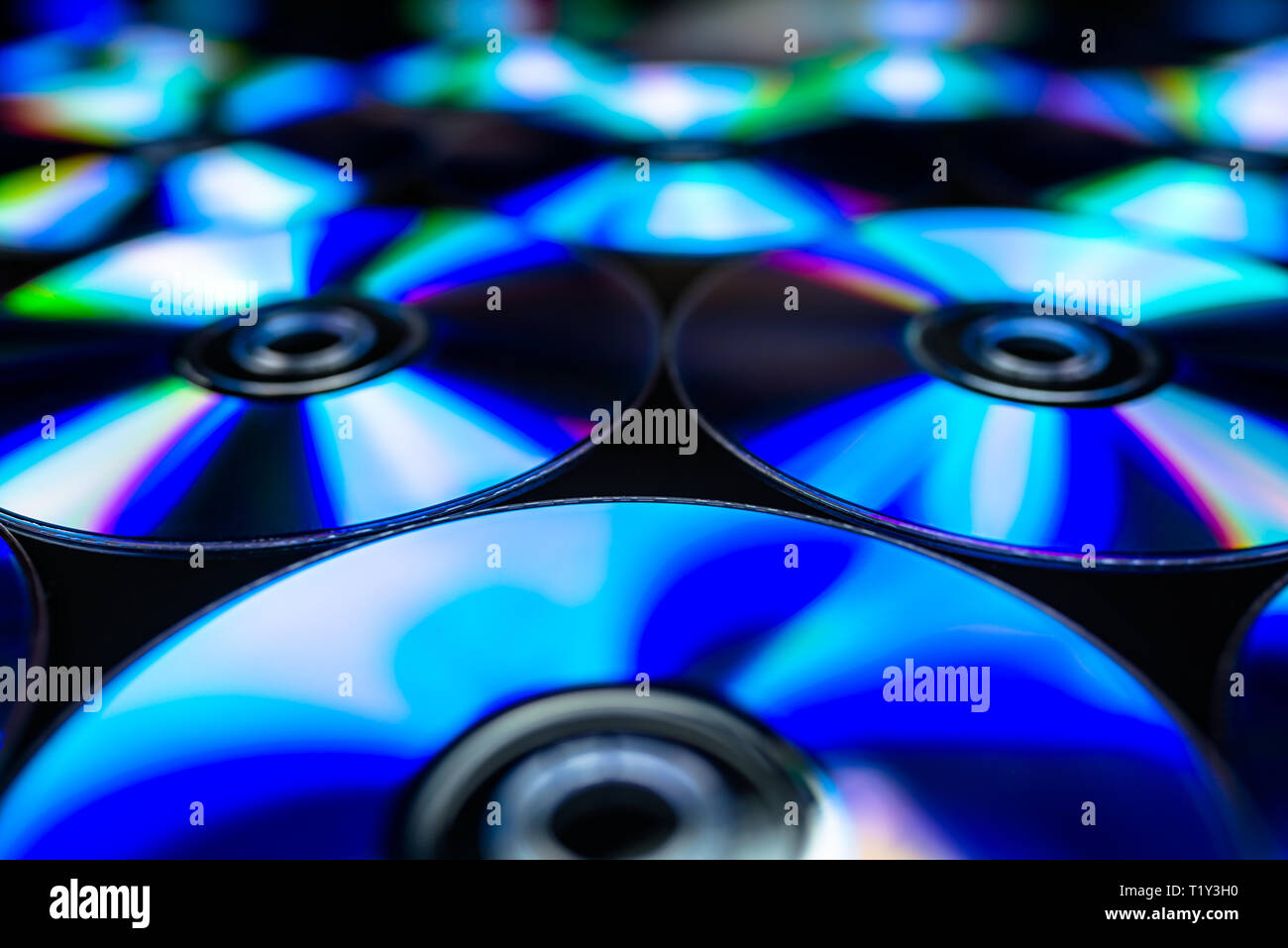 CDs / DVDs lying on a black background with reflections of light Stock ...