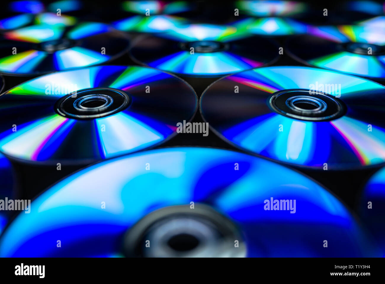 CDs / DVDs lying on a black background with reflections of light Stock ...