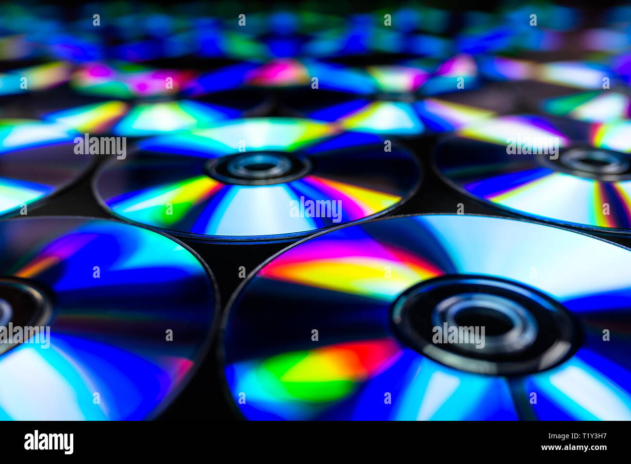CDs / DVDs lying on a black background with reflections of light Stock ...