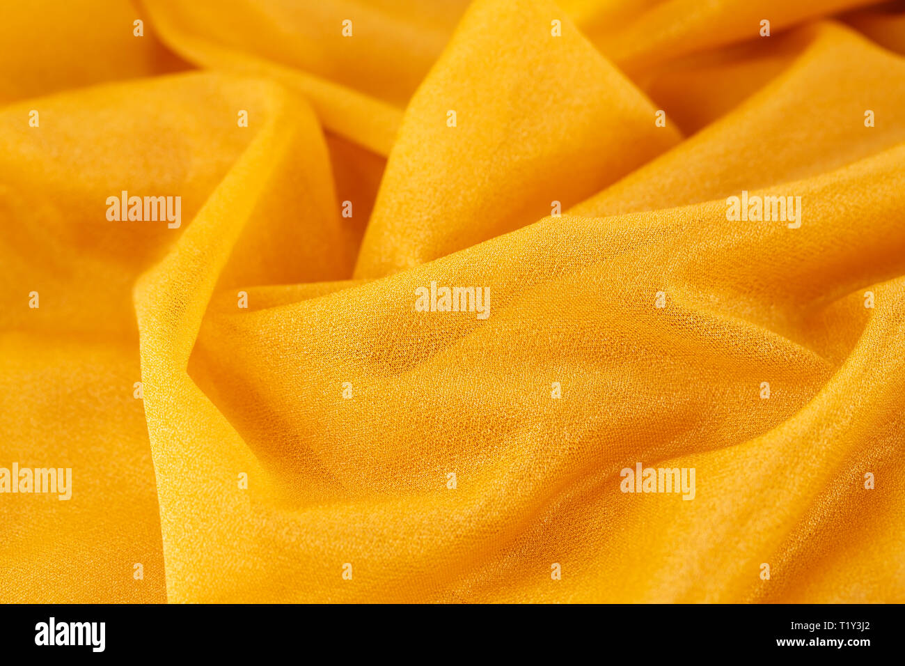 Yellow wrinkled fabric as a background Stock Photo - Alamy