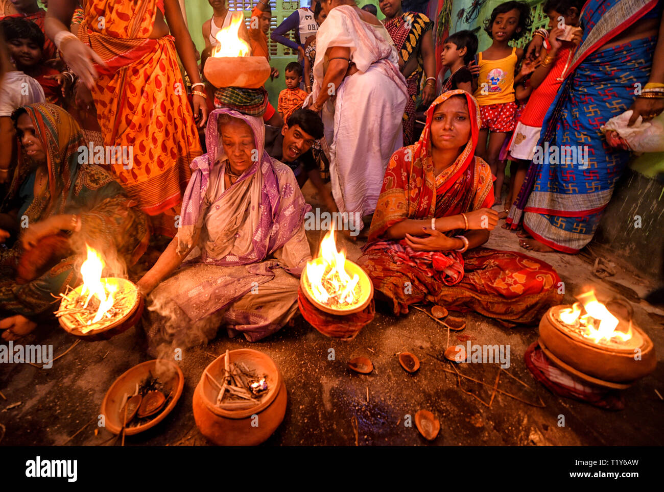 A hindu woman seen seated with a burning fire pot on her head as a ...