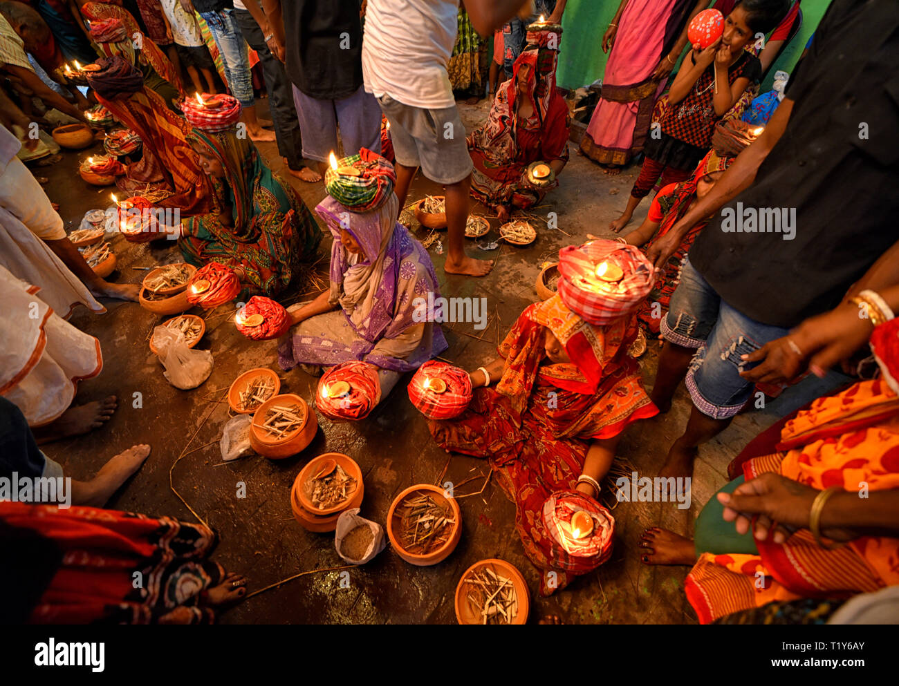 Hindu women are seen seated with burning fire pots on their head as a ...