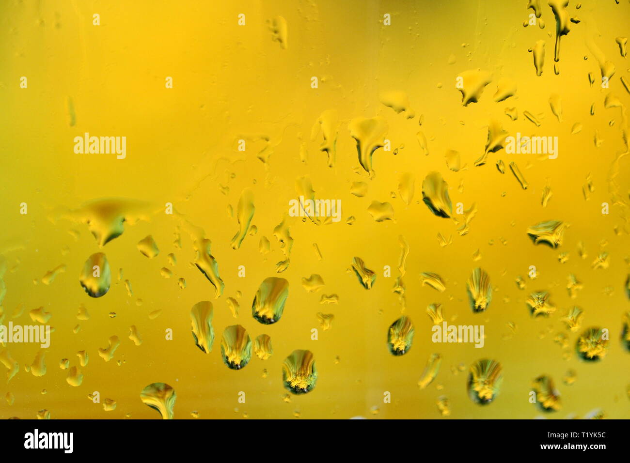 Autumn rain on window with yellow background Stock Photo - Alamy