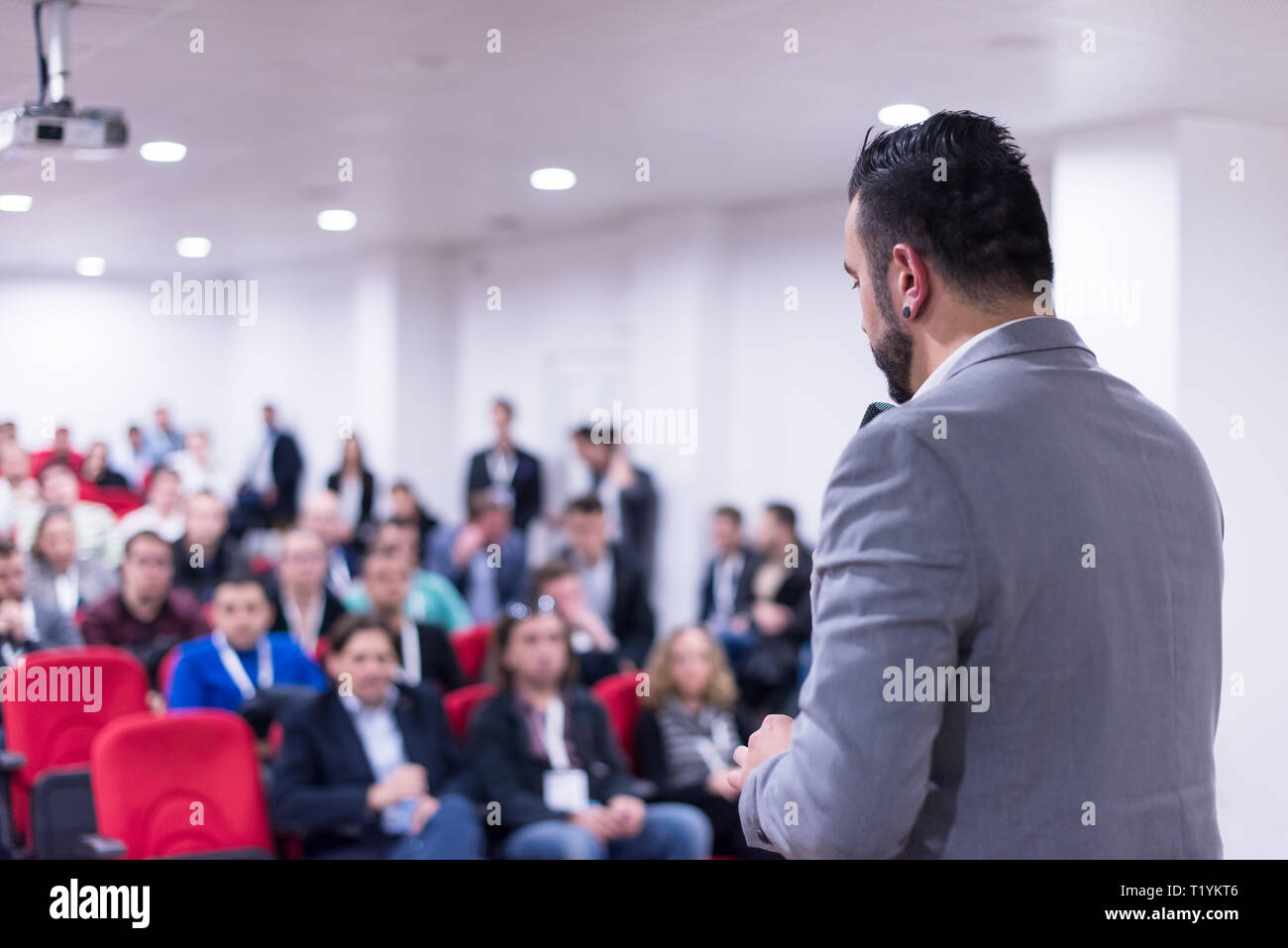 rear view of young successful businessman at business conference room ...