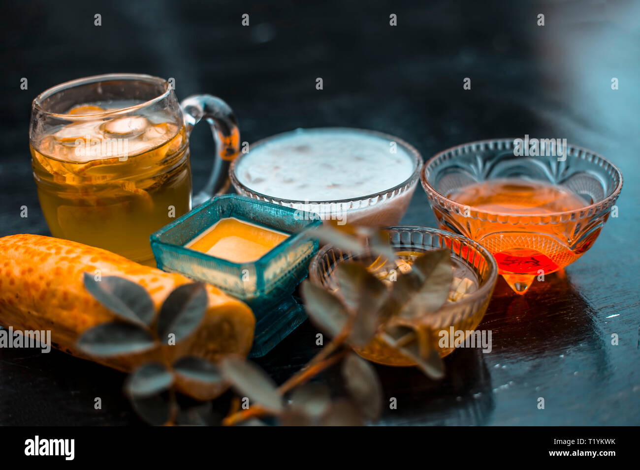 Floral face pack of curd,cucumber, aloe vera gel and honey on wooden ...