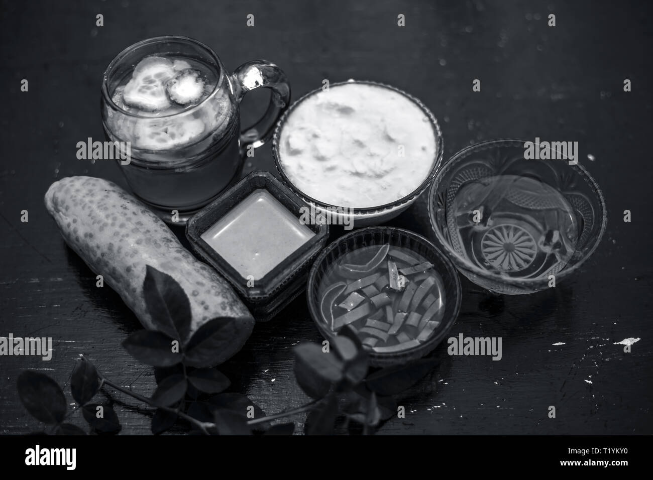 Floral face pack of curd,cucumber, aloe vera gel and honey on wooden ...