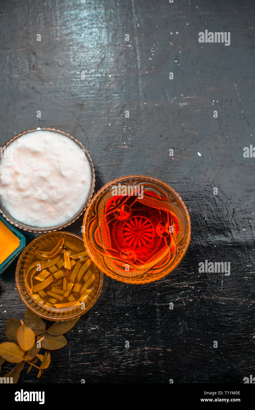 Floral face pack of curd,cucumber, aloe vera gel and honey on wooden ...