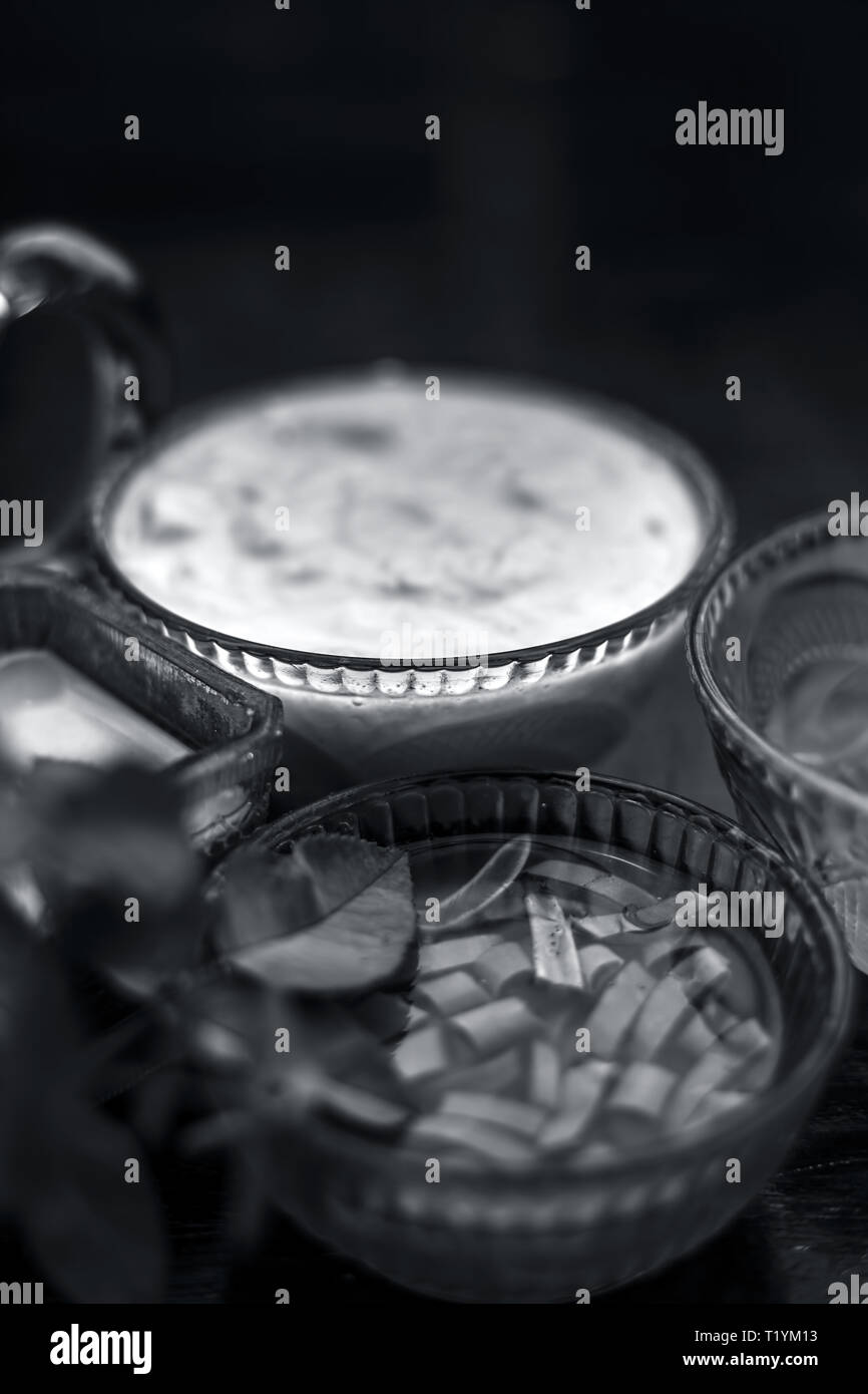 Floral face pack of curd,cucumber, aloe vera gel and honey on wooden ...