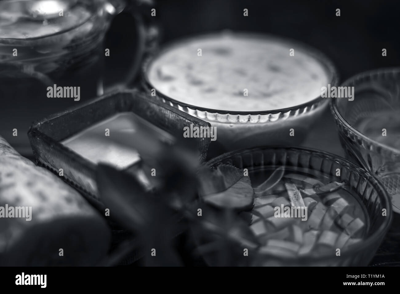 Floral face pack of curd,cucumber, aloe vera gel and honey on wooden ...