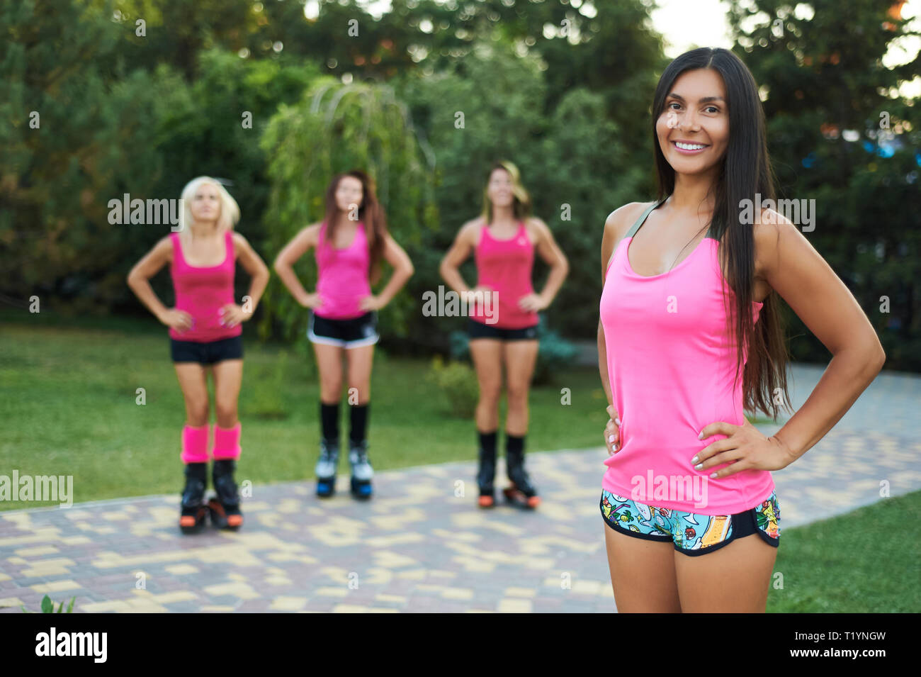 group of girls doing exercises in kangoo jumping boots. outdoor fitness ...