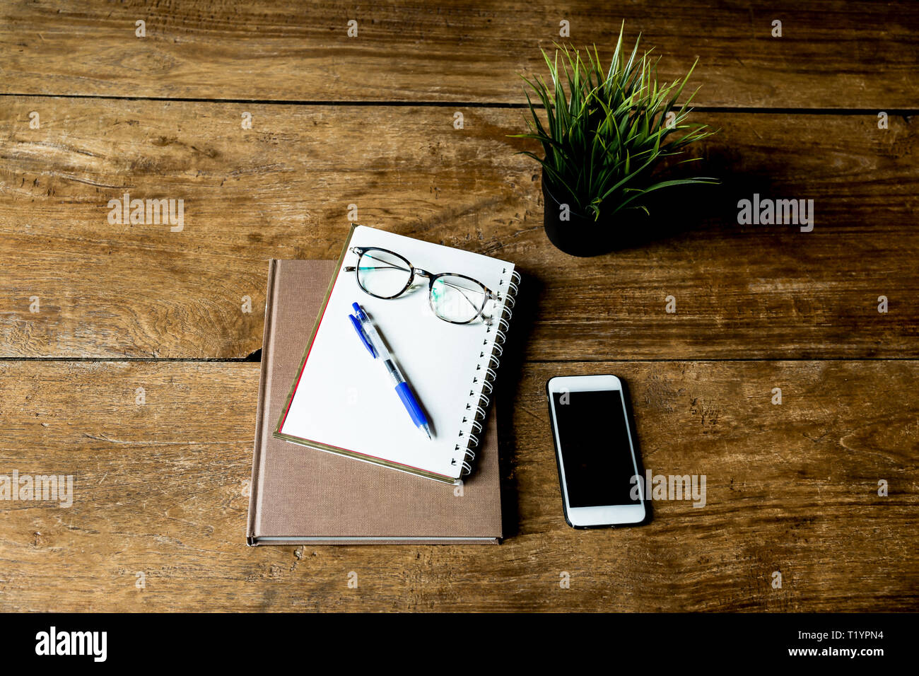 Working object notebook and pen with glasses and cell phone on wooden ...