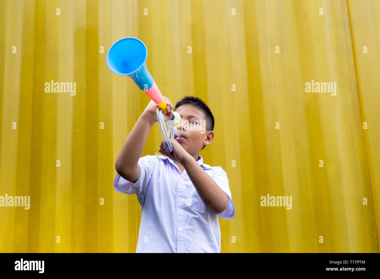 Child blowing a horn hi-res stock photography and images - Alamy