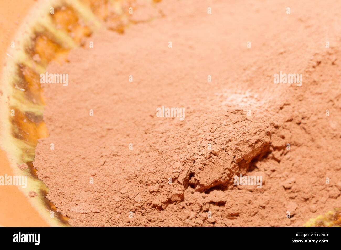 Dry cocoa powder poured into a brown ceramic plate Stock Photo - Alamy