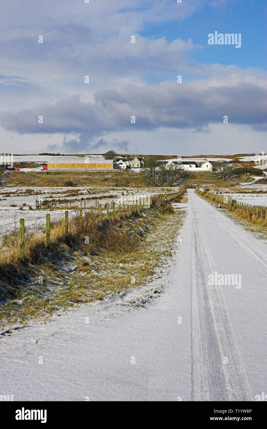 Snow-covered road on Loch Gruinart RSPB Reserve, island of Islay ...