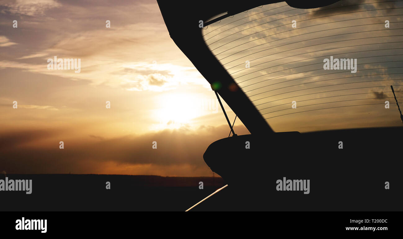 Outdoor car trunk at sunset, photo against the sun - travel concept ...