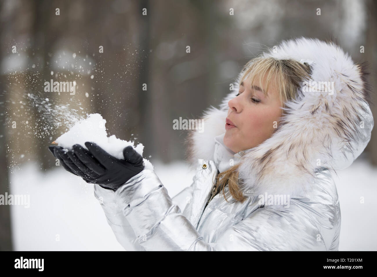 Beautiful caucasian woman blowing snow hi-res stock photography and images - Alamy