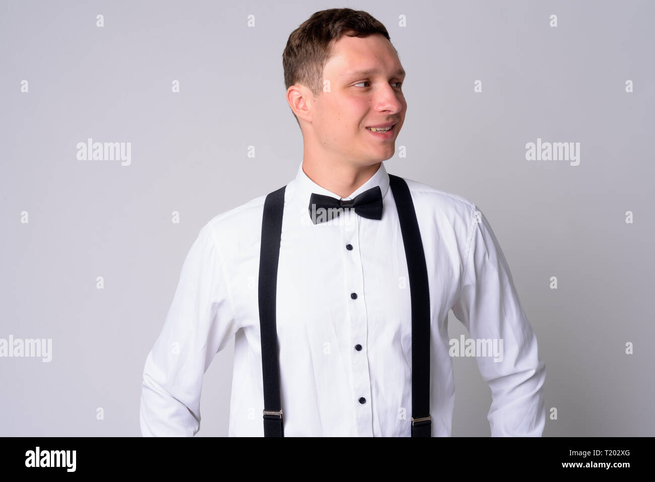 Portrait of happy young businessman with suspenders thinking Stock ...